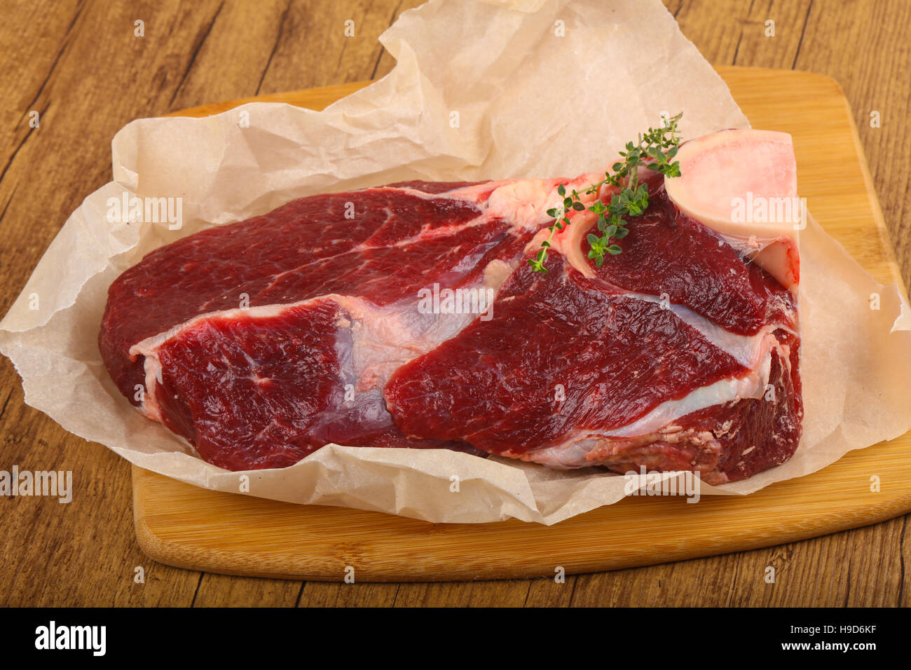 Raw beef with thyme - ready for cooking Stock Photo - Alamy