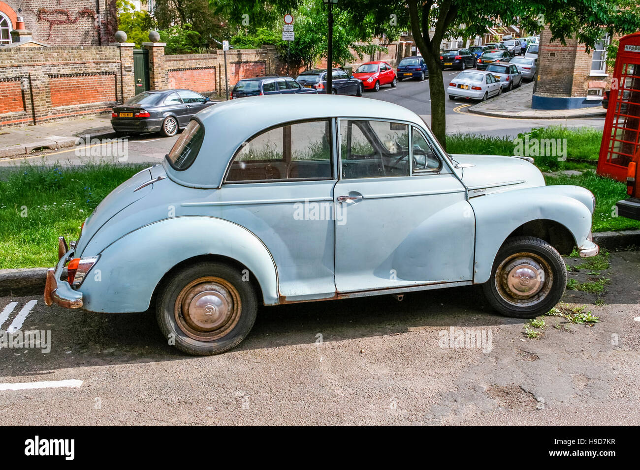 A slightly dilapidated light blue two-door Morris Minor 1000 classic ...