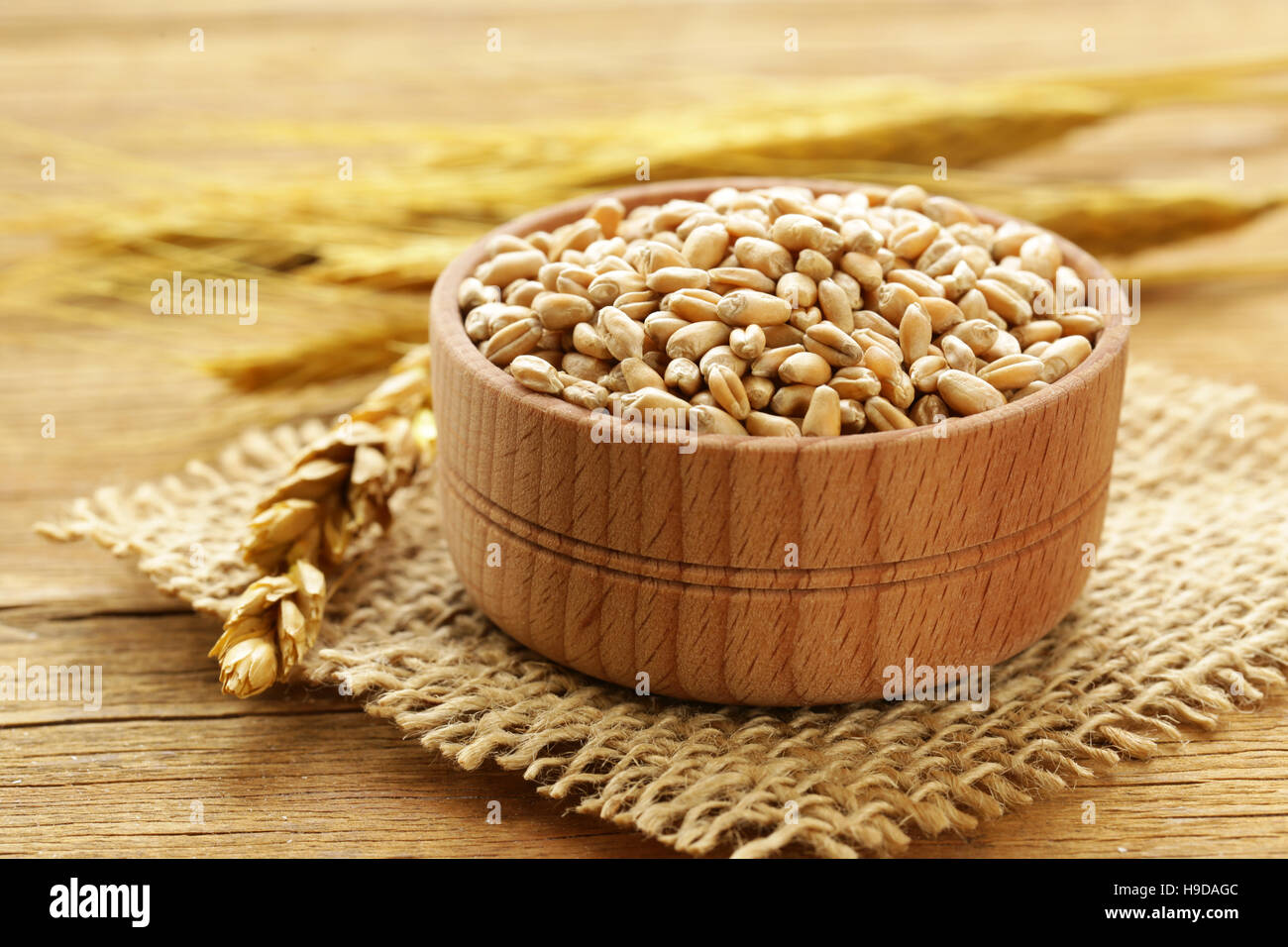 Natural organic wheat. Grain in a wooden bowl Stock Photo - Alamy