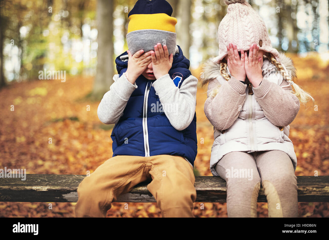 Kids closing eyes with hands. Horizontal outdoors shot Stock Photo - Alamy