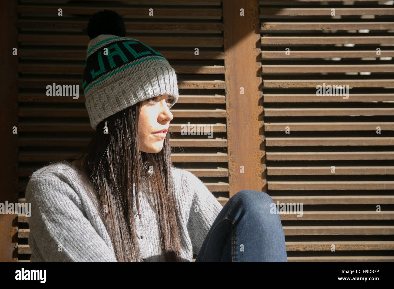 girl posing with a woolen cap on a door Stock Photo - Alamy