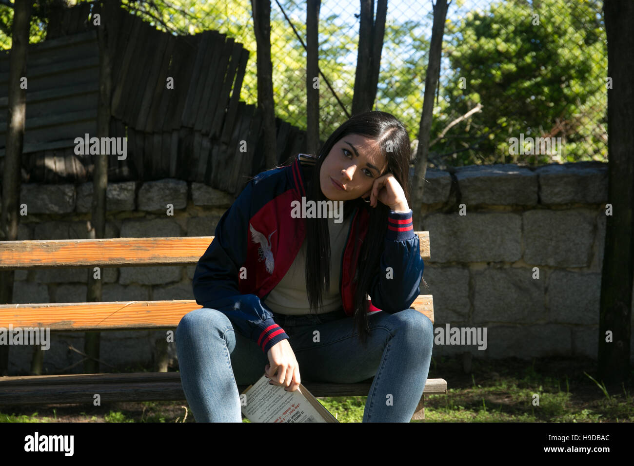 girl posing in a bench Stock Photo - Alamy