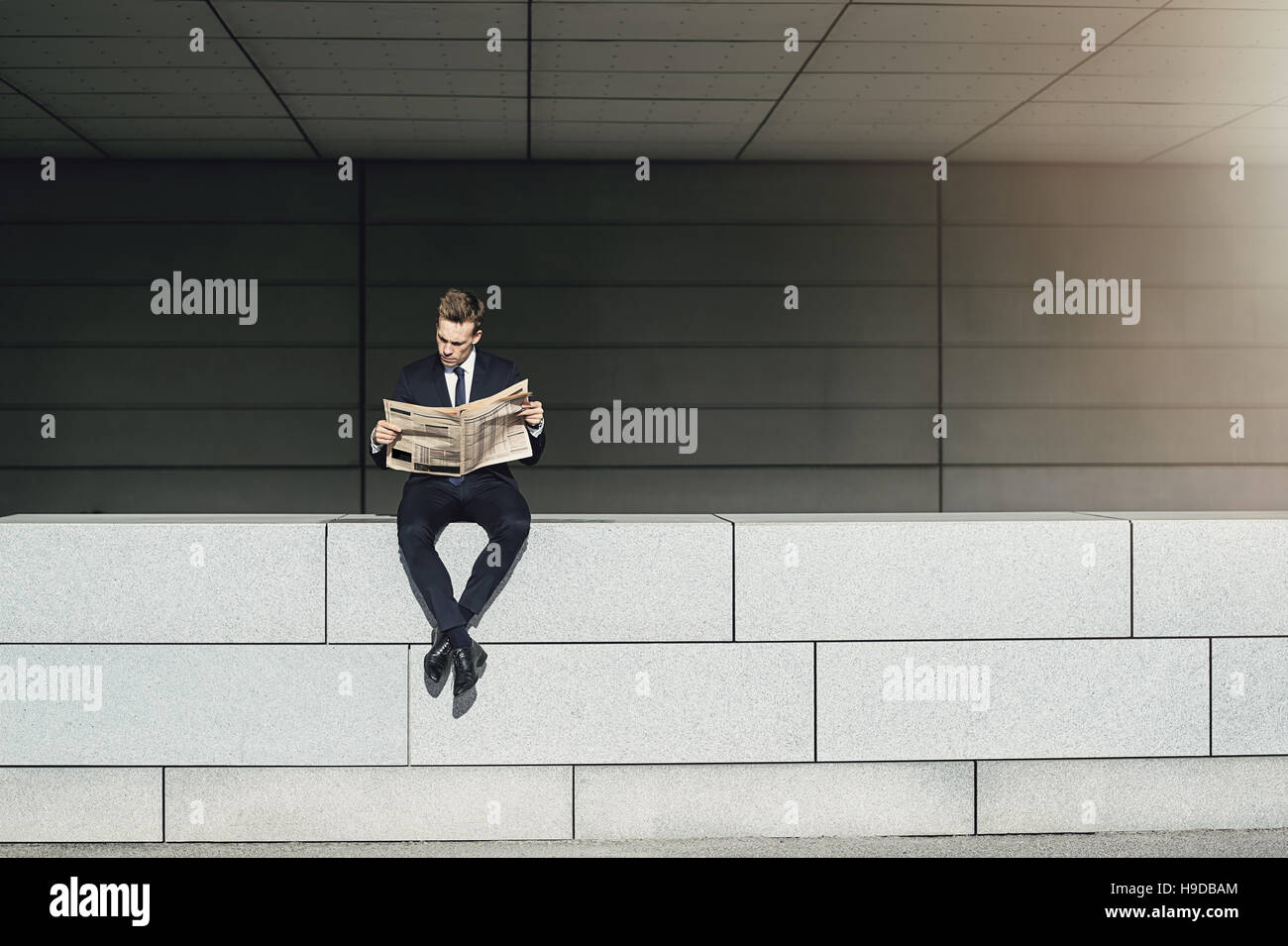 Reading a newspaper stylish businessman. Horizontal outdoors shot Stock ...