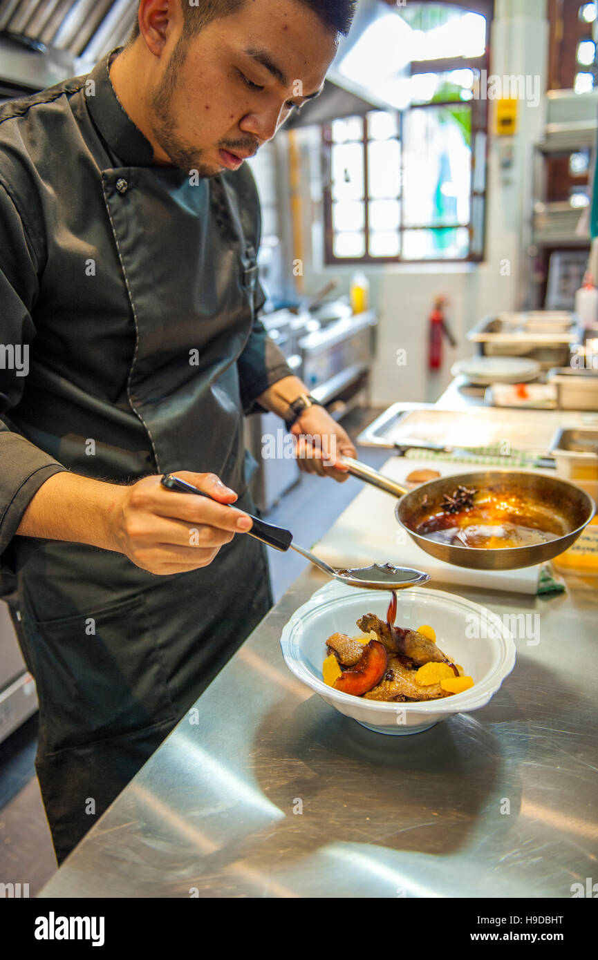 Chef Zachary Choong prepares duck with star anise in the kitchen of ...