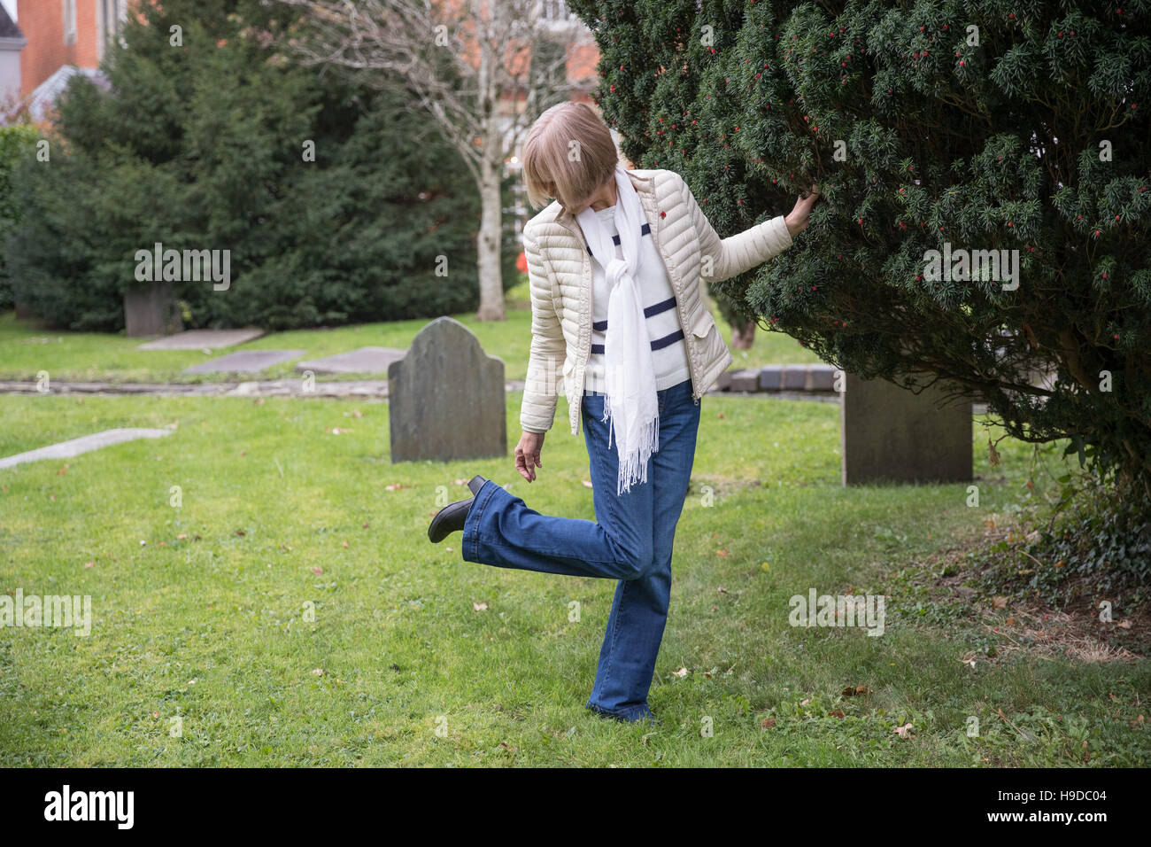 Lady checks her shoe worried she has stepped in dog poo Stock Photo - Alamy
