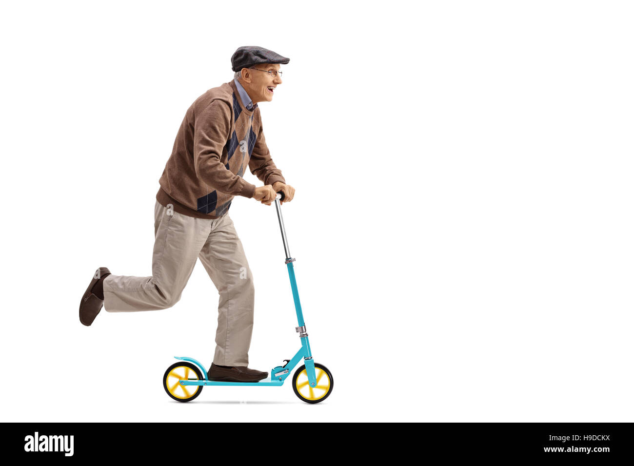 Full length profile shot of a senior riding a scooter isolated on white ...