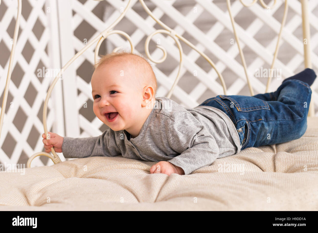 Adorable baby boy in sunny bedroom. Newborn child relaxing. Family ...