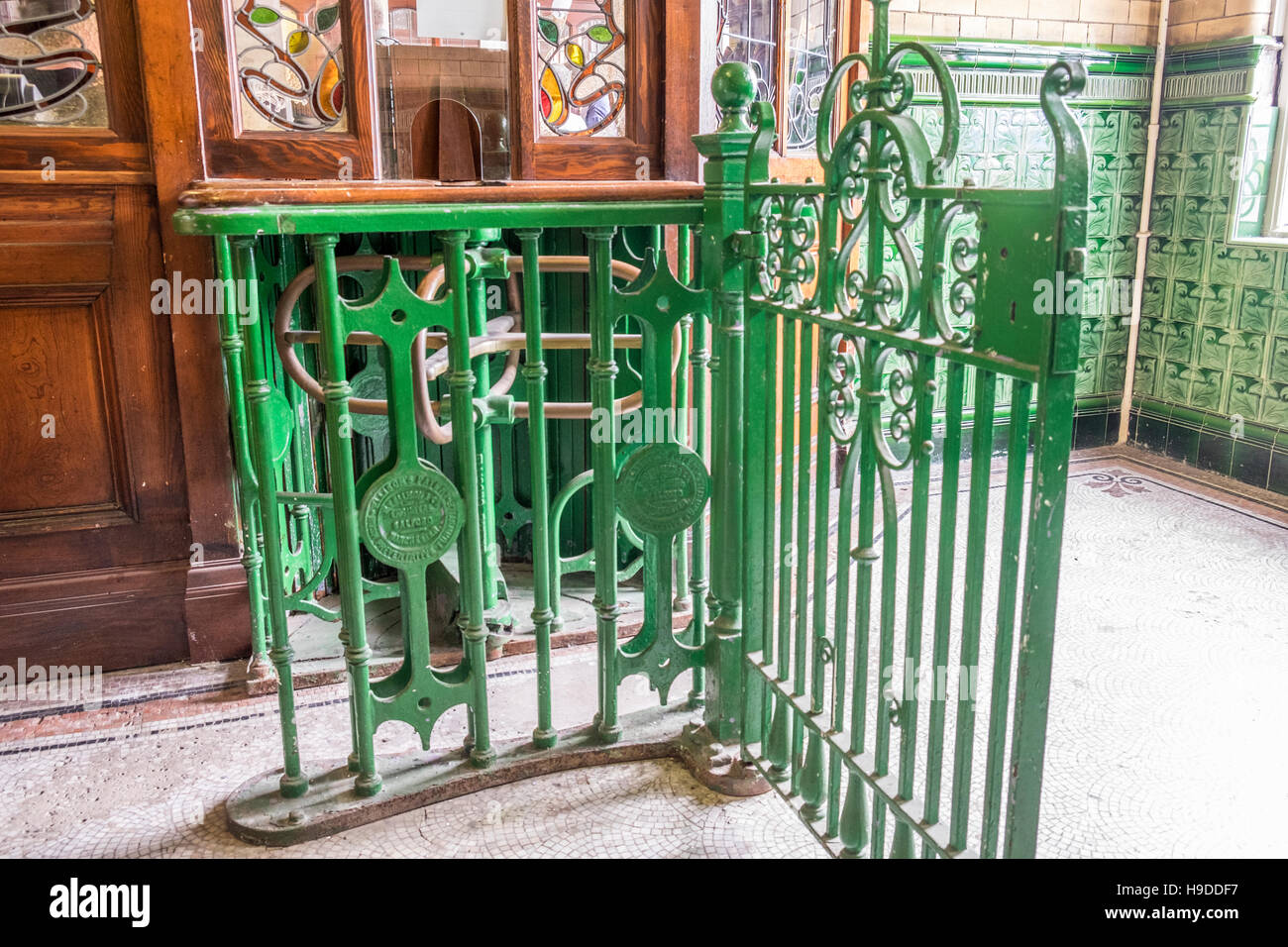 A green old fashioned turnstile allowing people into a building Stock ...
