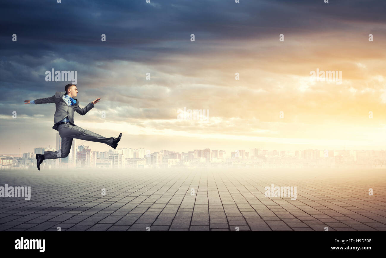 Businessman jumping high Stock Photo - Alamy