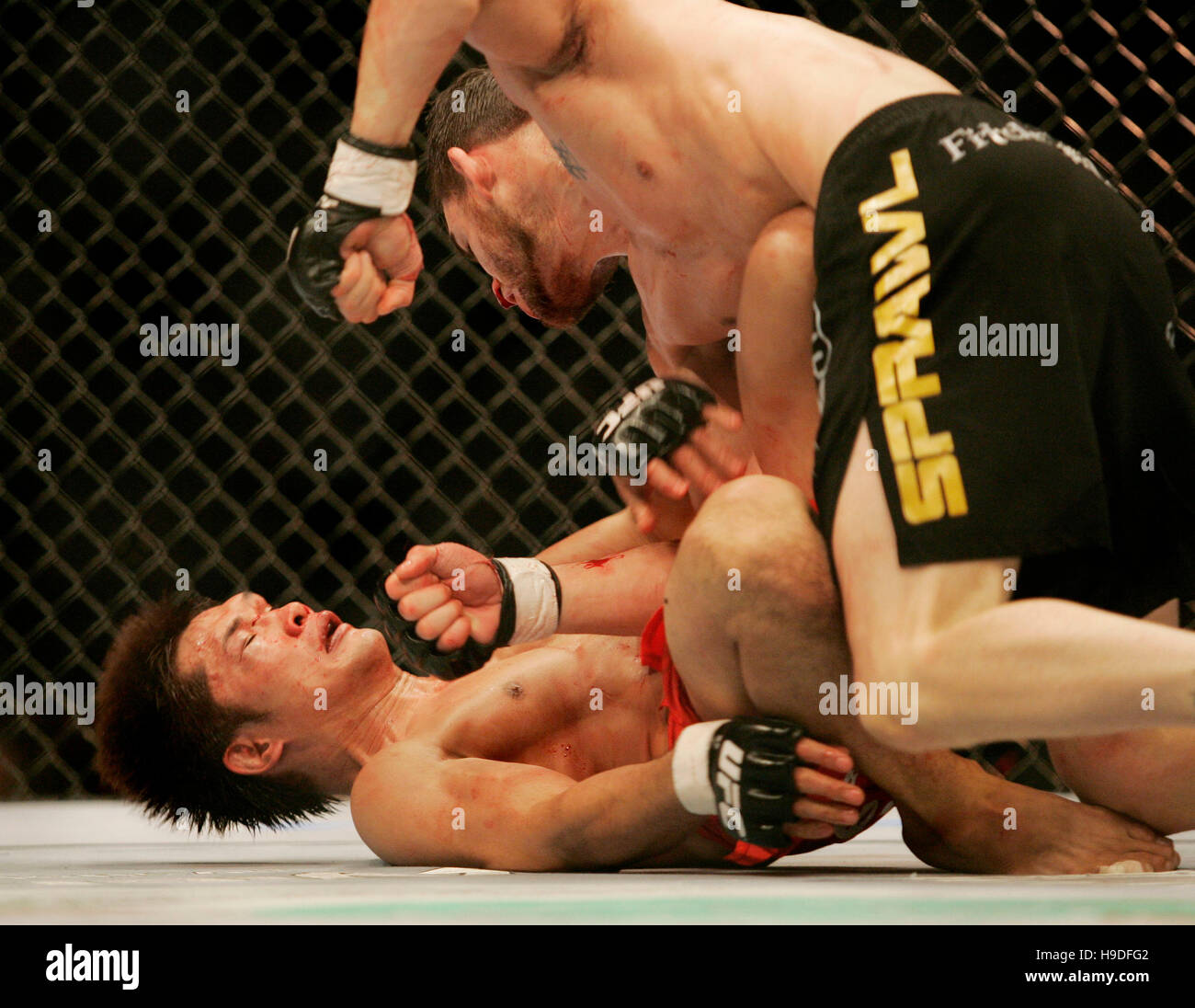 Jon Fitch, top, fights, Kuniyoshi Hironaka of Japan at the Ultimate ...