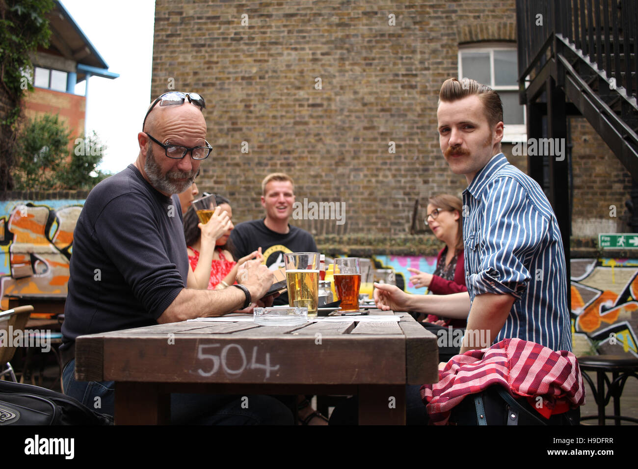 Family enjoying a pint in the afternoon Stock Photo - Alamy