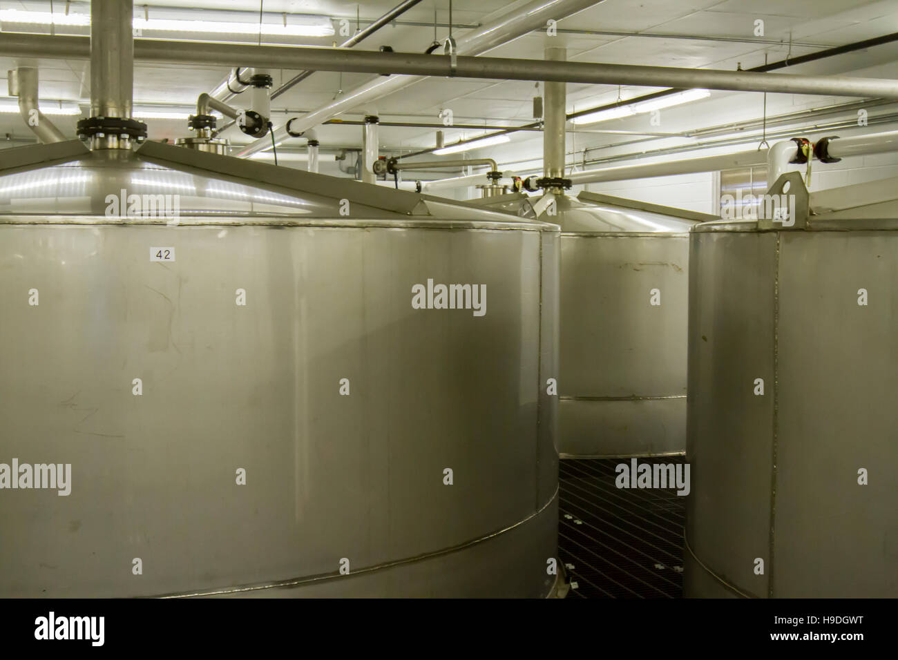 Inside modern fermentation room with large metal vats in bourbon ...