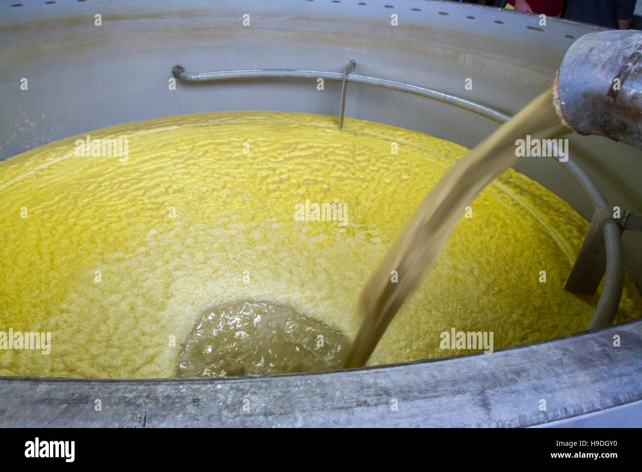 Fermentation tanks being filled with corn mash, water and yeast in ...