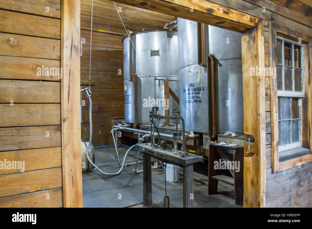 Barrel filling operations at craft bourbon distillery Stock Photo - Alamy