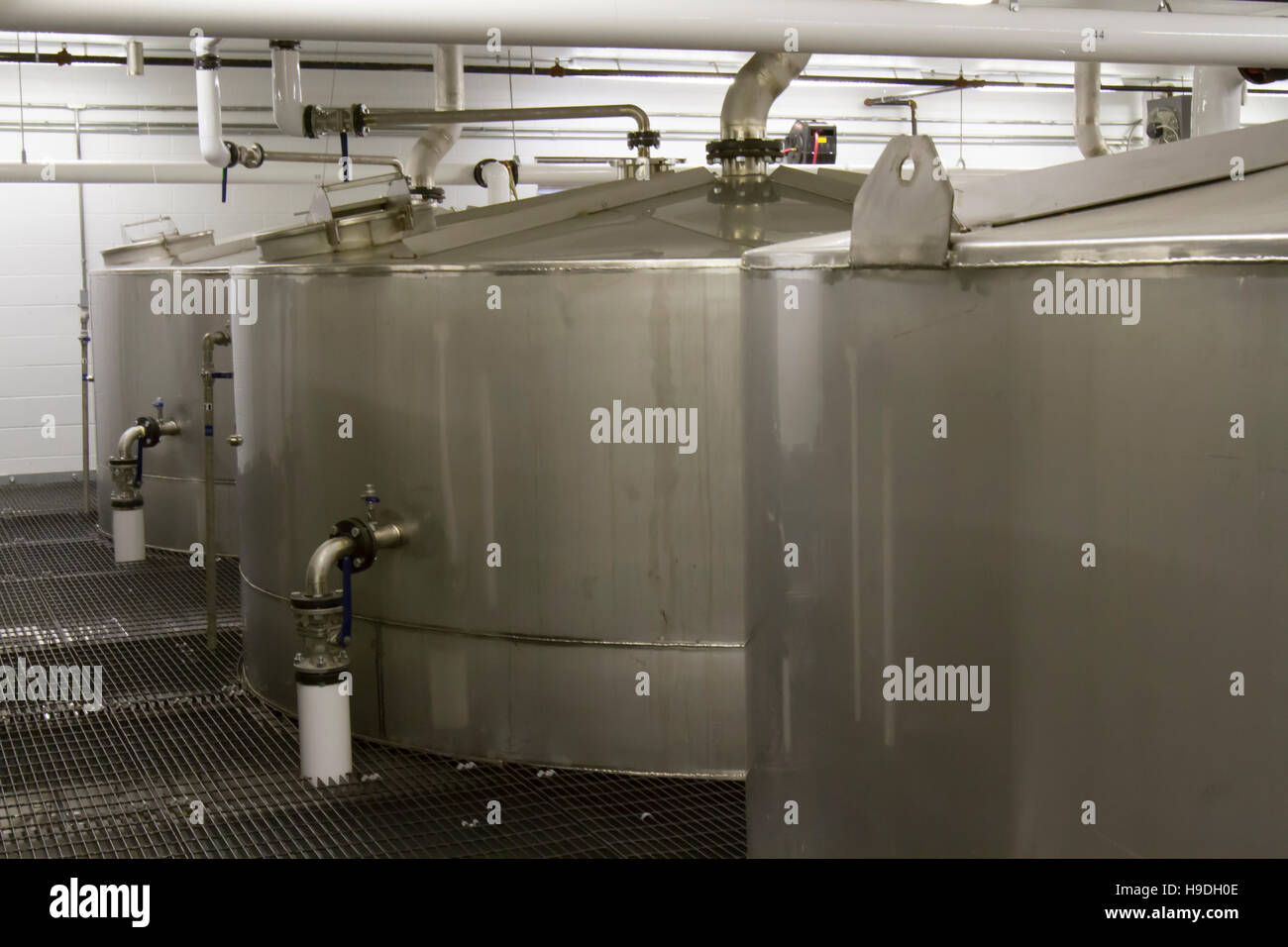 Inside modern fermentation room with large metal vats in bourbon ...