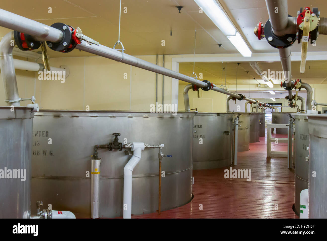 Inside modern fermentation room with large metal vats in bourbon ...