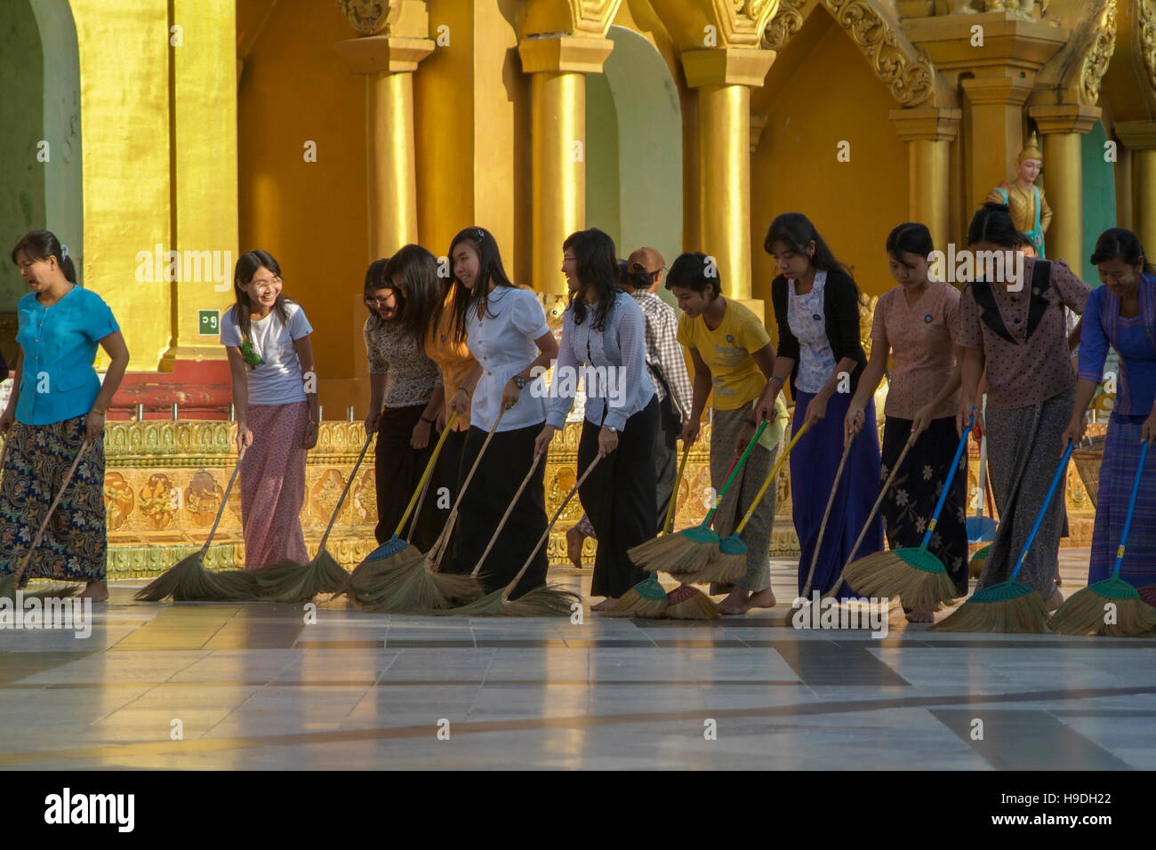 Women sweeping the floor at the Shwedagon Pagoda in Yangon, the most ...
