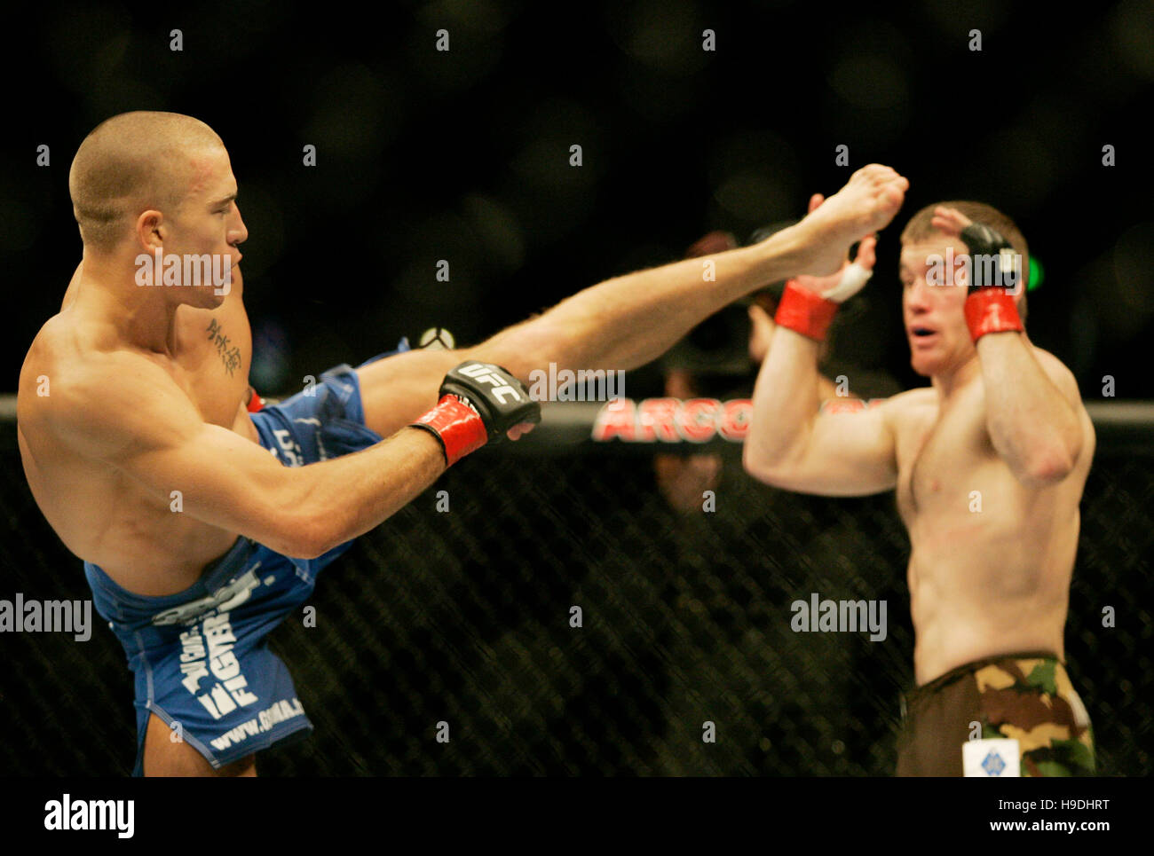 Georges St. Pierre, left, kicks Matt Hughes during the Ultimate ...