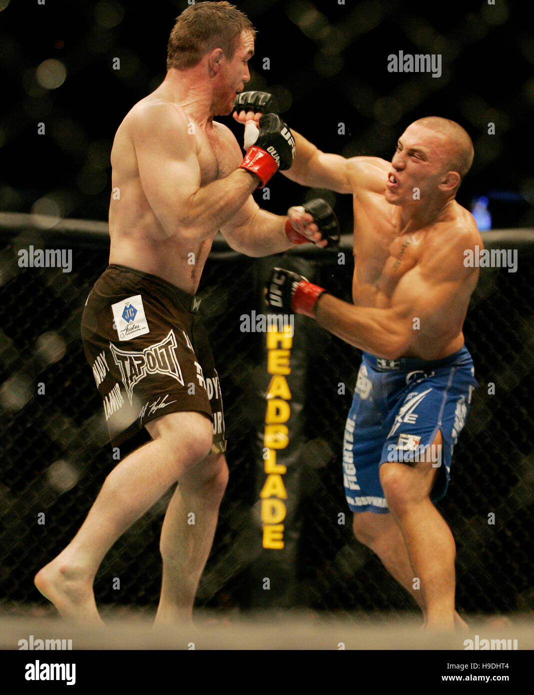 Georges St. Pierre, right, punches Matt Hughes during the Ultimate ...