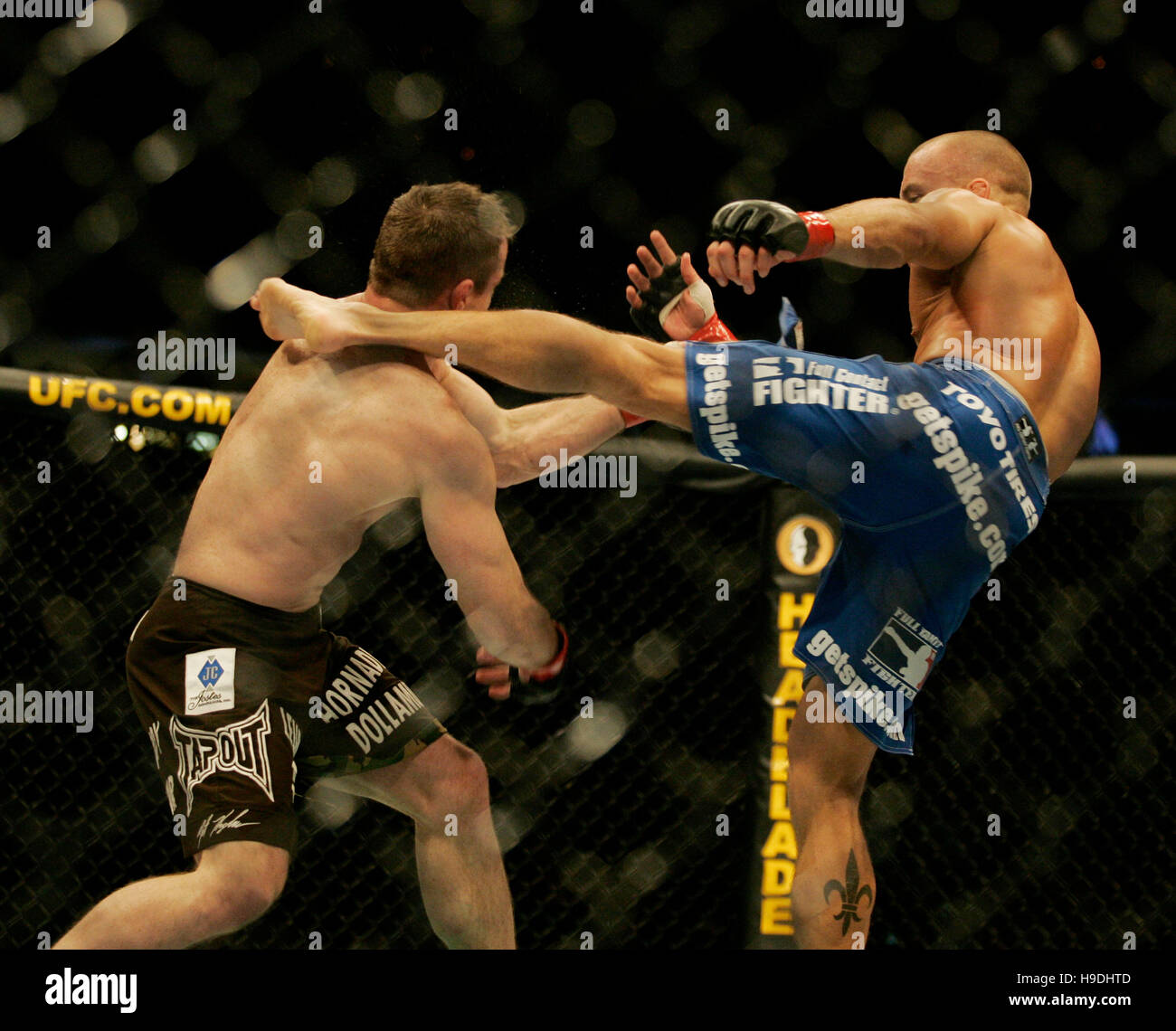 Georges St. Pierre, right, kicks Matt Hughes during the Ultimate ...