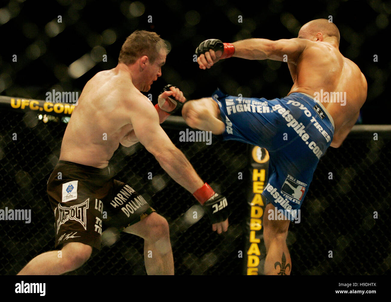 Georges St. Pierre, right, kicks Matt Hughes during the Ultimate ...