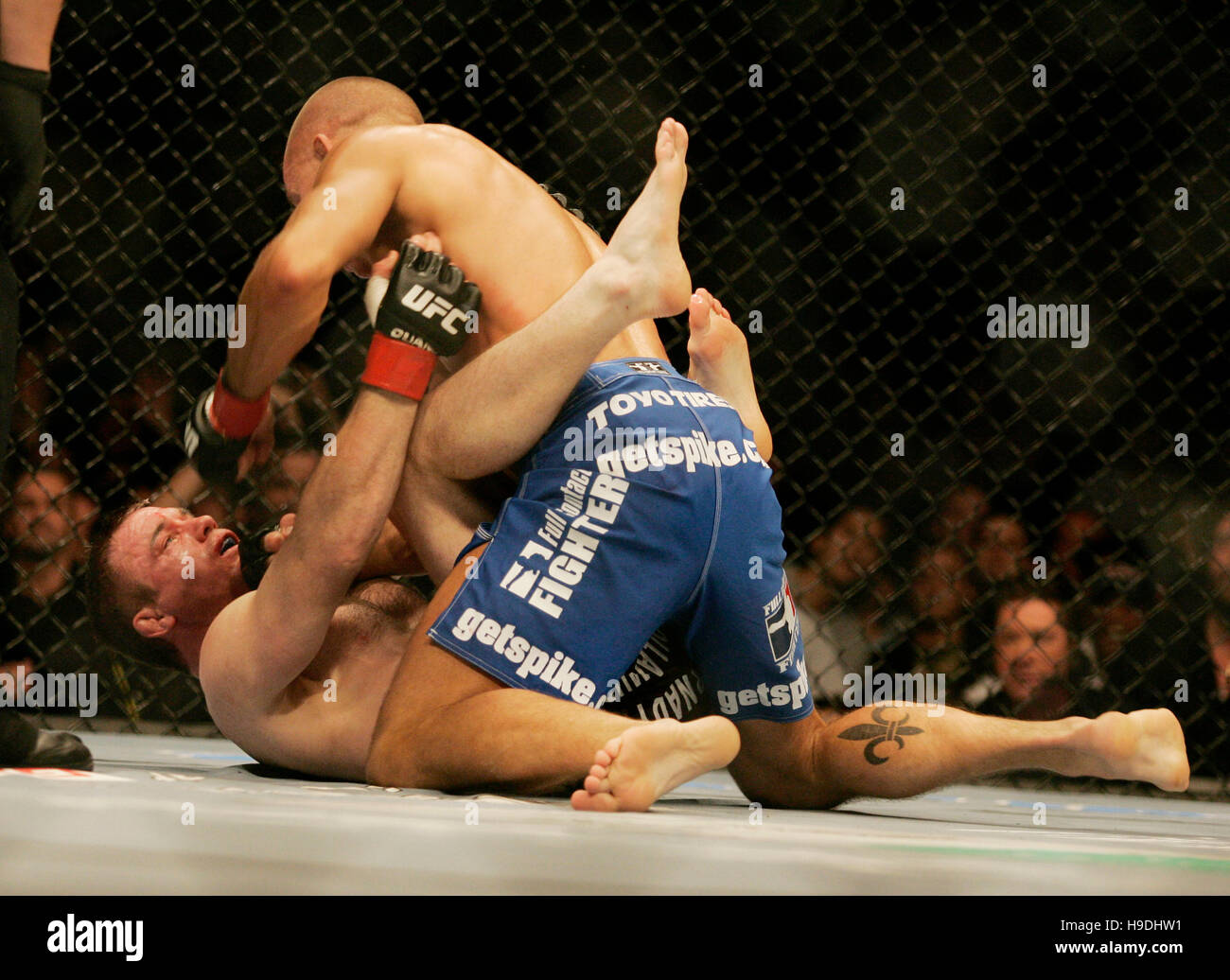 Georges St. Pierre, right, punches Matt Hughes during the Ultimate ...