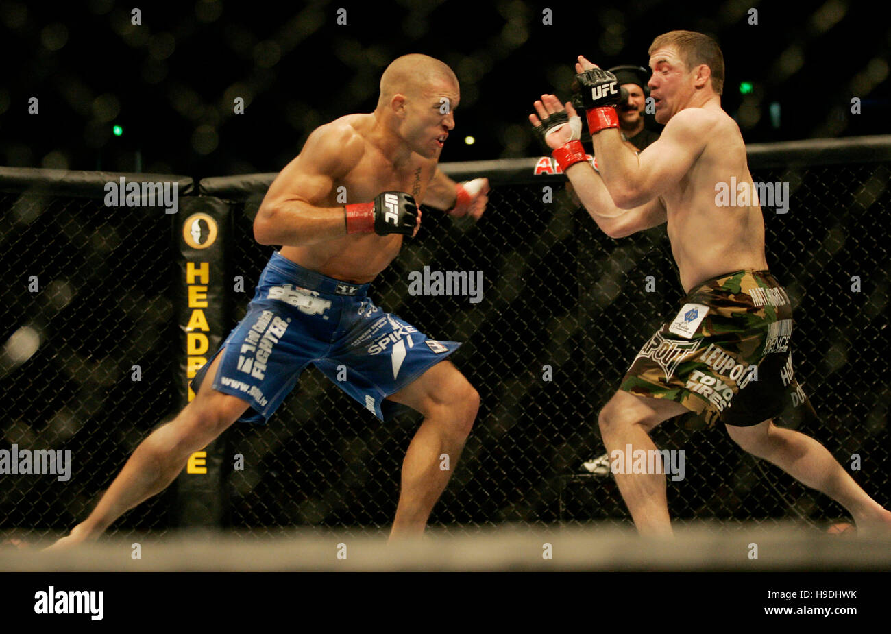 Georges St. Pierre, left, punches Matt Hughes during the Ultimate ...