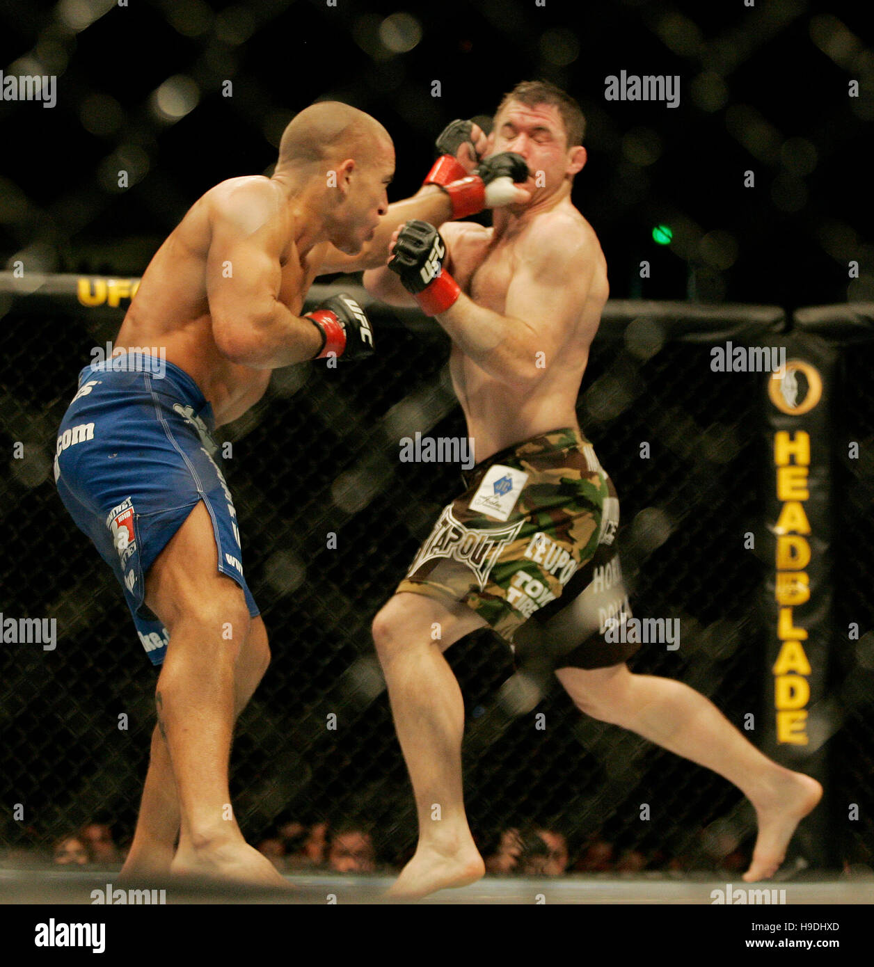 Georges St. Pierre, left, punches Matt Hughes during the Ultimate ...