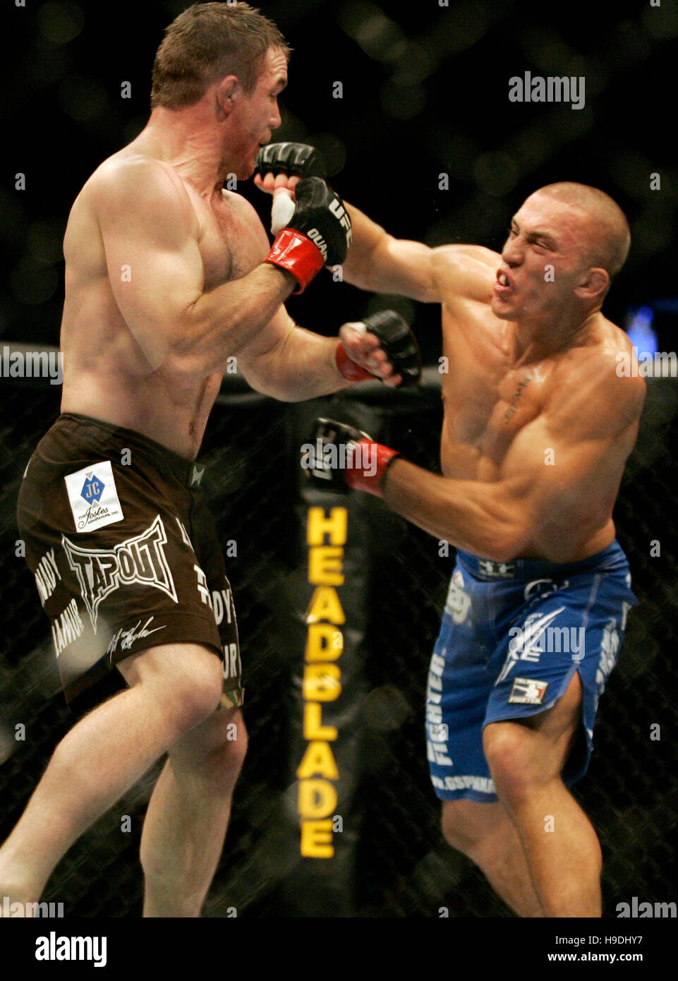 Georges St. Pierre, right, punches Matt Hughes during Ultimate Fighting ...