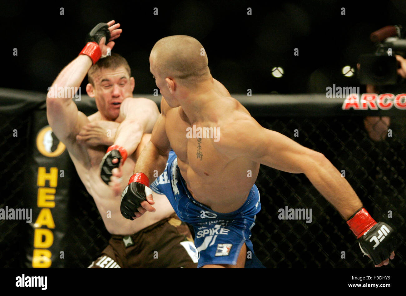 Georges St. Pierre, right, kicks Matt Hughes during Ultimate Fighting ...