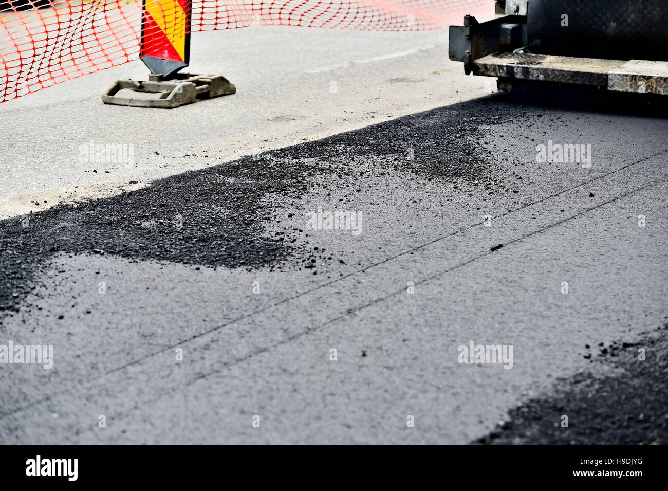 Asphalt paving with a steel wheel roller Stock Photo - Alamy