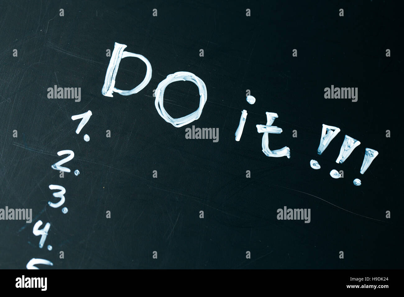 inscription do it list drawn with chalk on a school blackboard dark ...