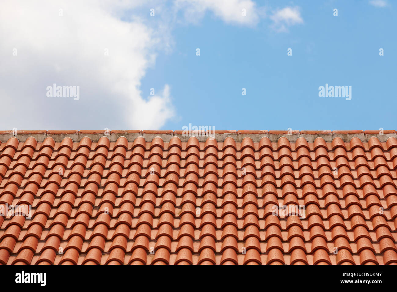 Orange tile roof over a blue sky. Horizontal format Stock Photo - Alamy