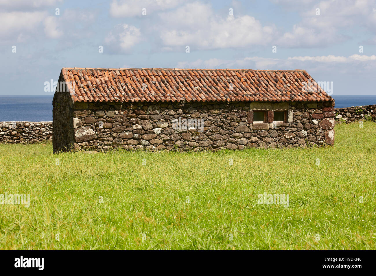 Antique stone house in the countryside with ocean background. Azores ...