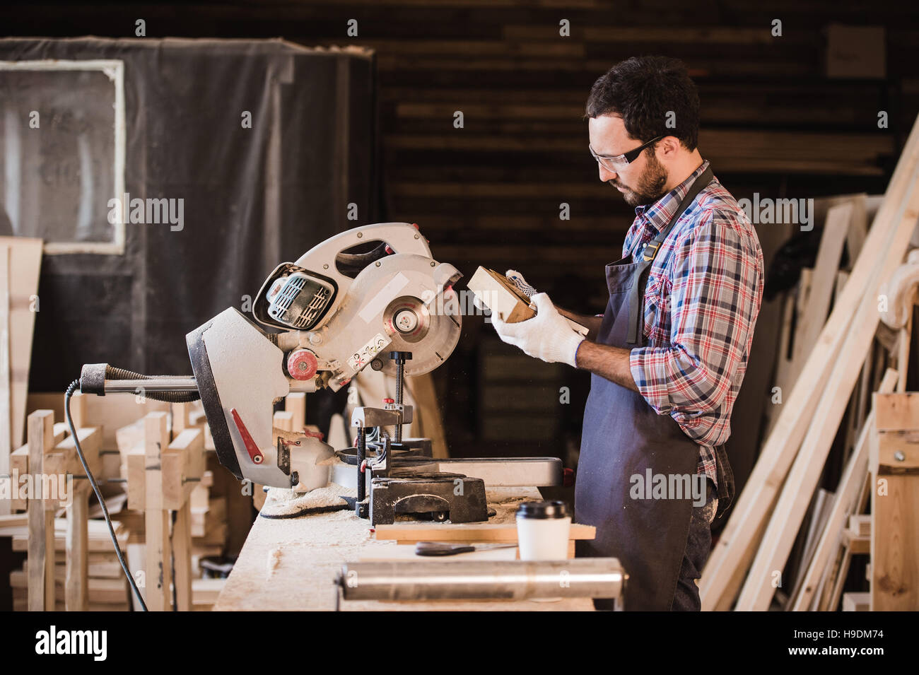 profession, carpentry, woodwork people concept - carpenter with wood ...