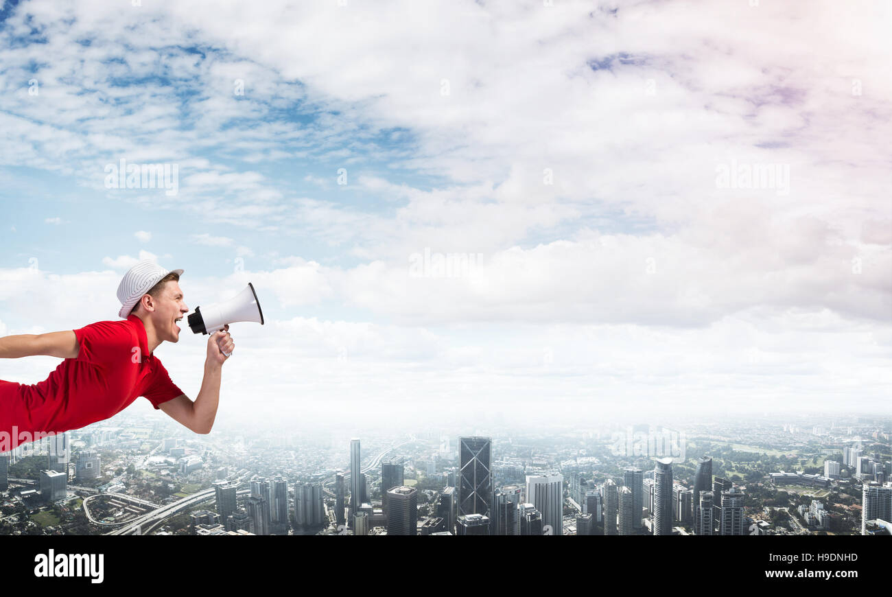 Guy screaming in loudspeaker Stock Photo - Alamy