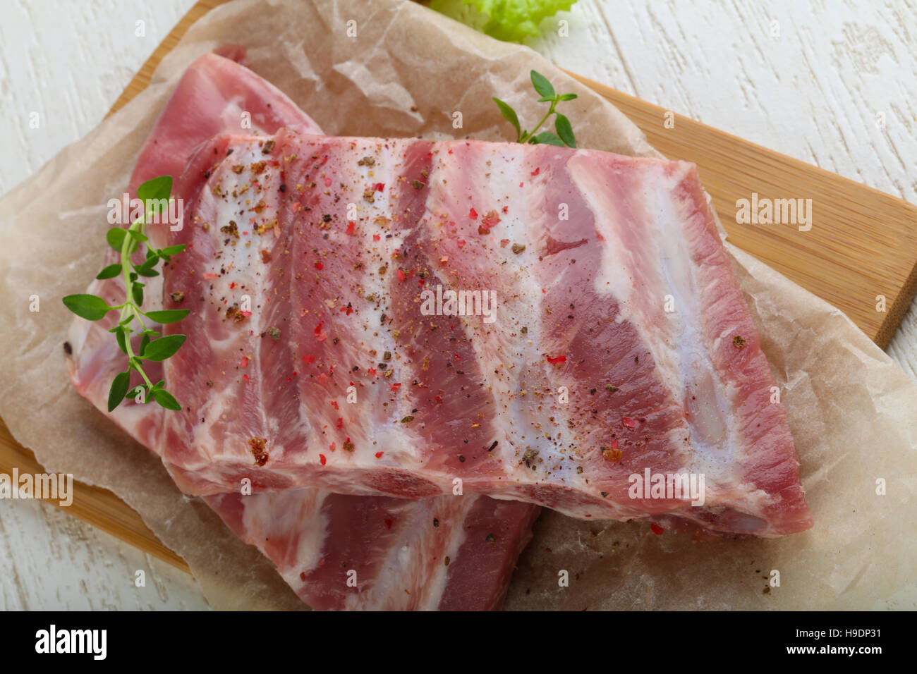 Raw pork ribs with herbs and spices Stock Photo - Alamy