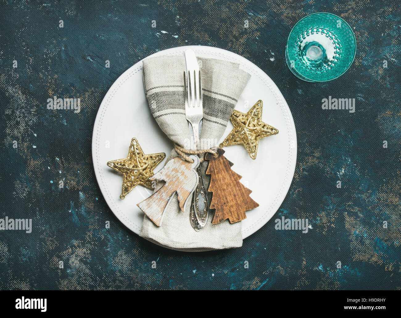 Christmas, New Year holiday table setting over dark blue background ...