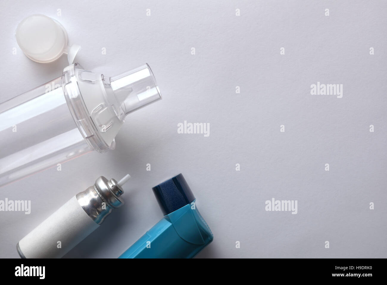 Cartridge and blue medicine inhaler and inhalation chamber on white ...