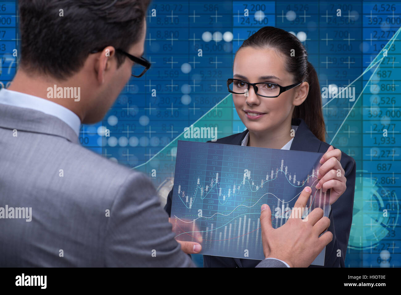 Business people discussing stock chart trends Stock Photo - Alamy