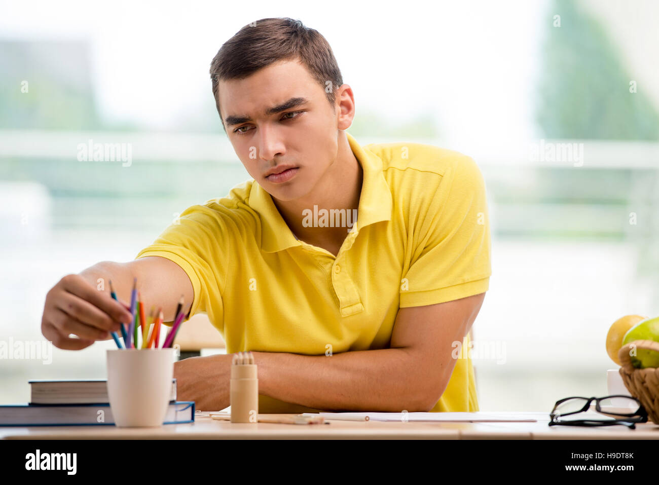 Young man drawing pictures in studio Stock Photo - Alamy