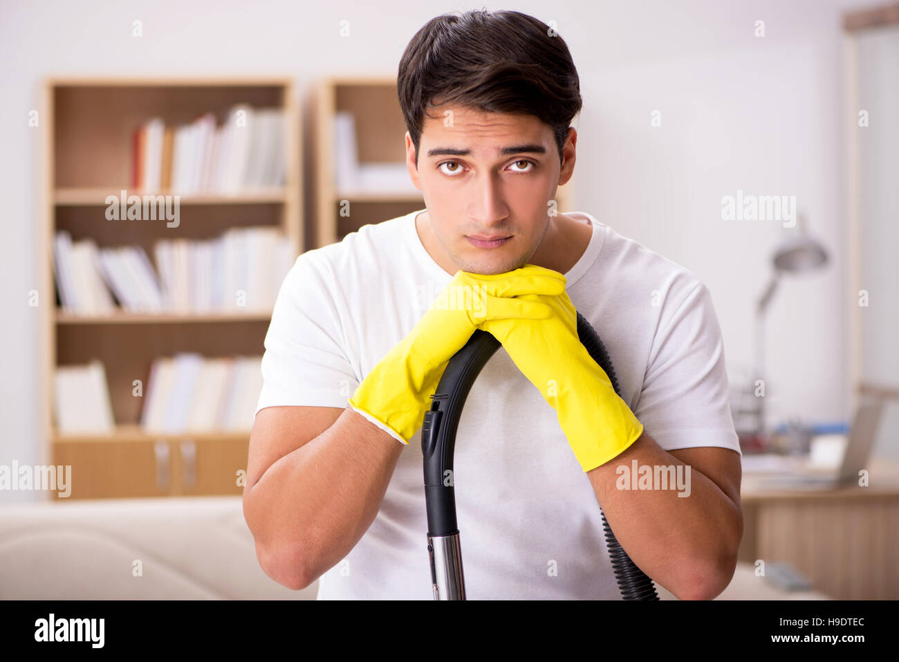 Man cleaning home with vacuum cleaner Stock Photo - Alamy