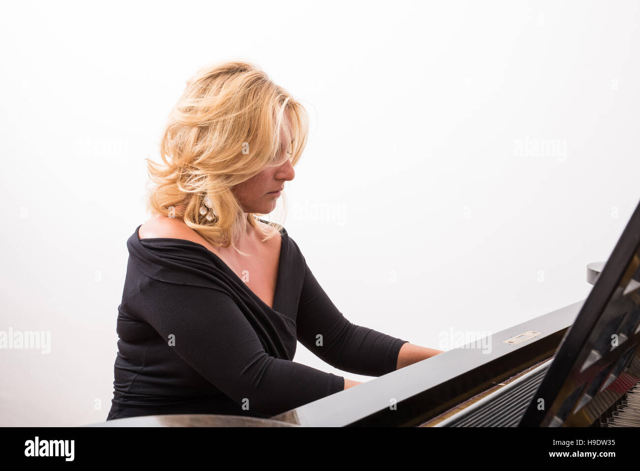 Elegant classical musician woman playing on piano Stock Photo - Alamy