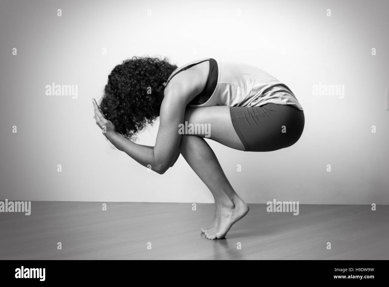 Woman making egg shape position Stock Photo - Alamy