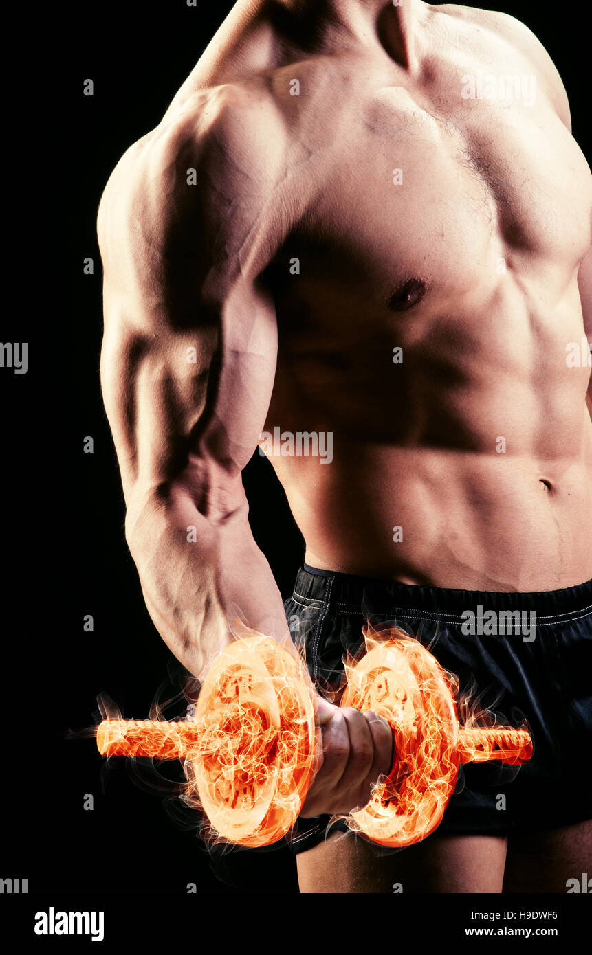 Muscular ripped bodybuilder with burning dumbbells Stock Photo - Alamy