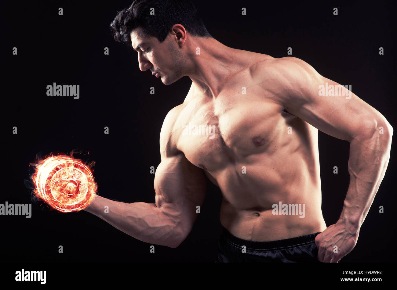 Muscular ripped bodybuilder with burning dumbbells Stock Photo - Alamy