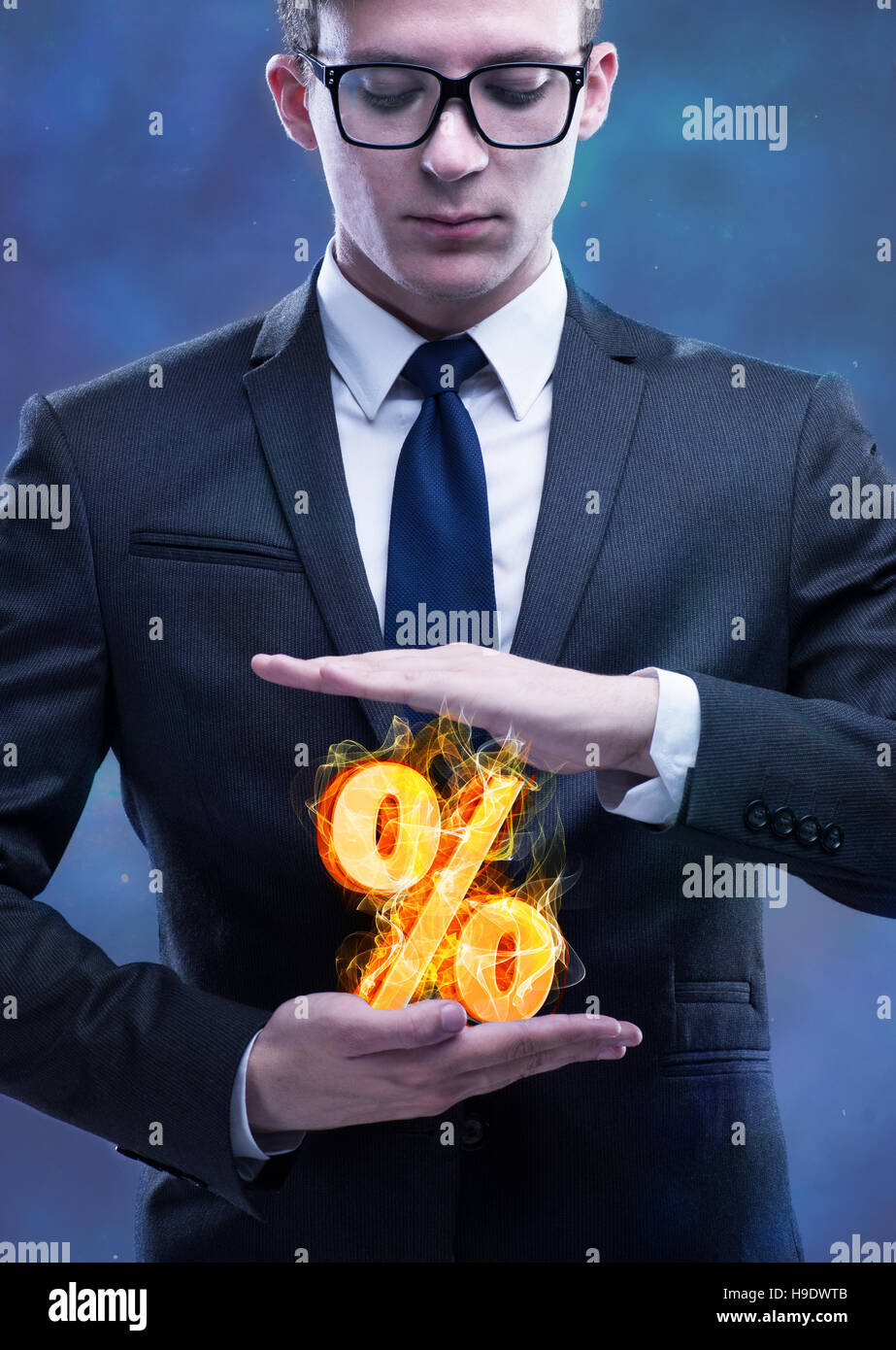 Businessman with percent sign in high interest concept Stock Photo - Alamy