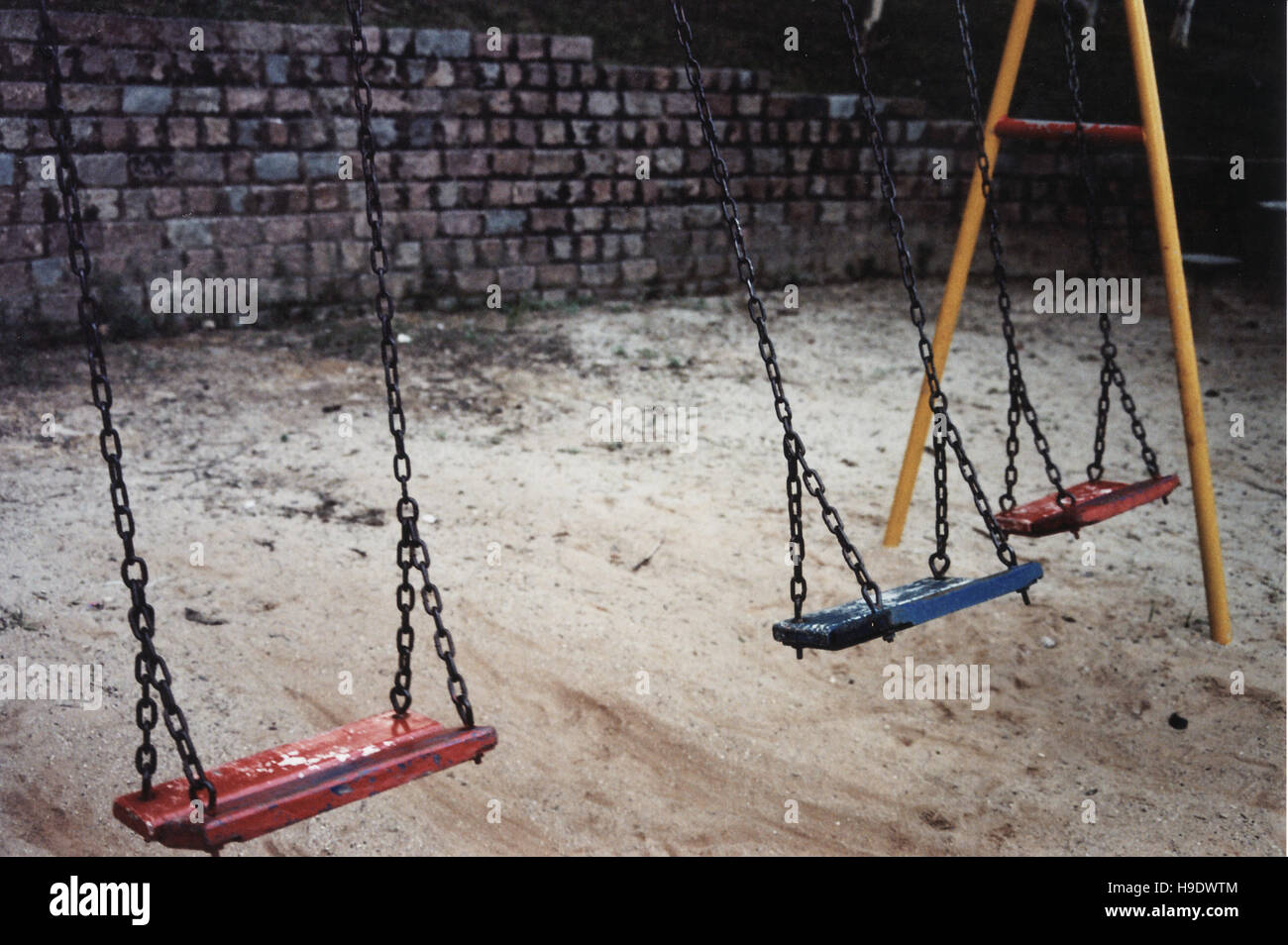 Swings swinging by themselves Stock Photo - Alamy
