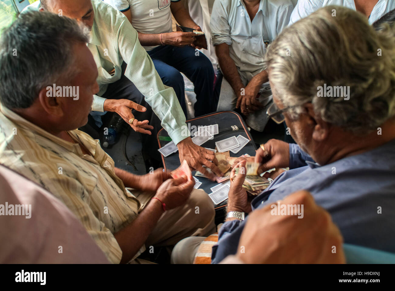 Men gambling rupees in a card game on the 1898 built, World Heritage ...