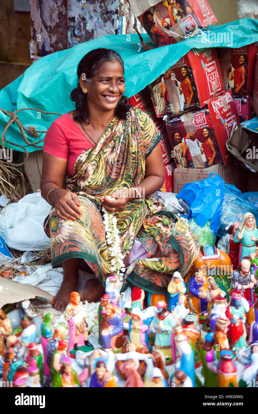 A woman selling catholic statues on the street in front of the ...
